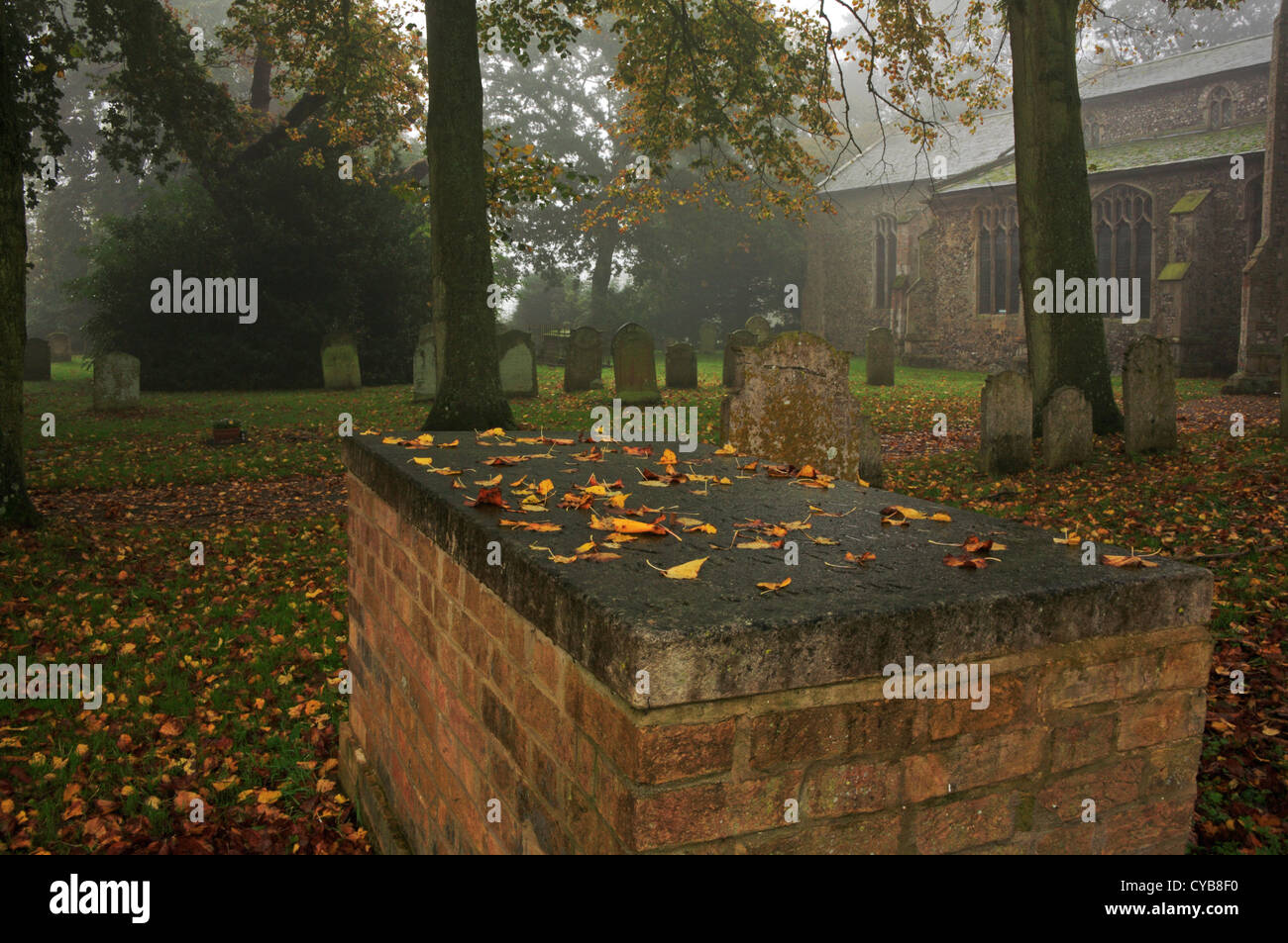 An autumn scene in a country churchyard at Barton Turf, Norfolk ...