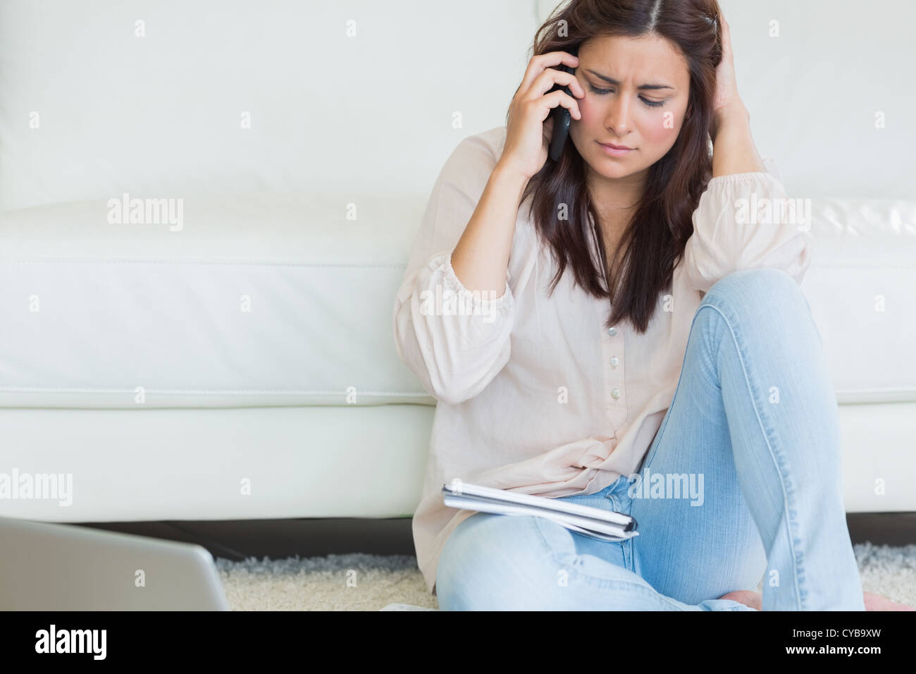 Women sitting on the carpet and calling Stock Photo - Alamy