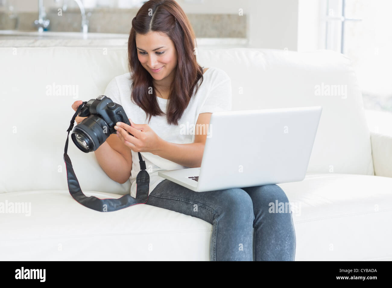 Brunette viewing pictures on the camera Stock Photo - Alamy