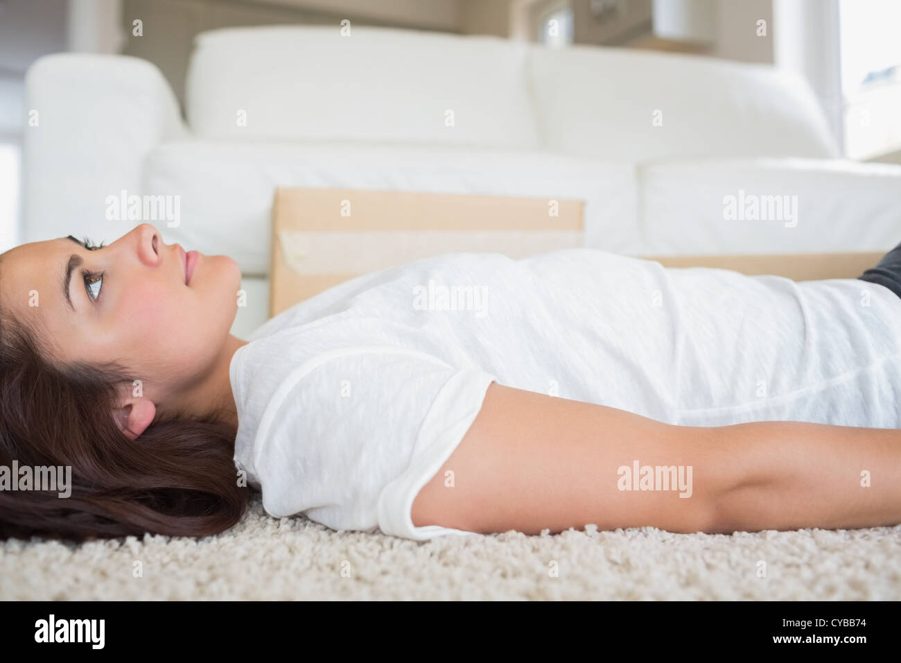 Woman lying on rug Stock Photo - Alamy