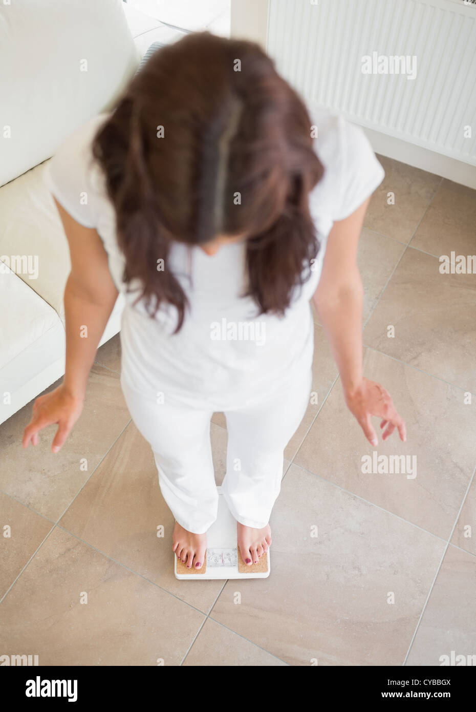 Woman checking her weight Stock Photo - Alamy
