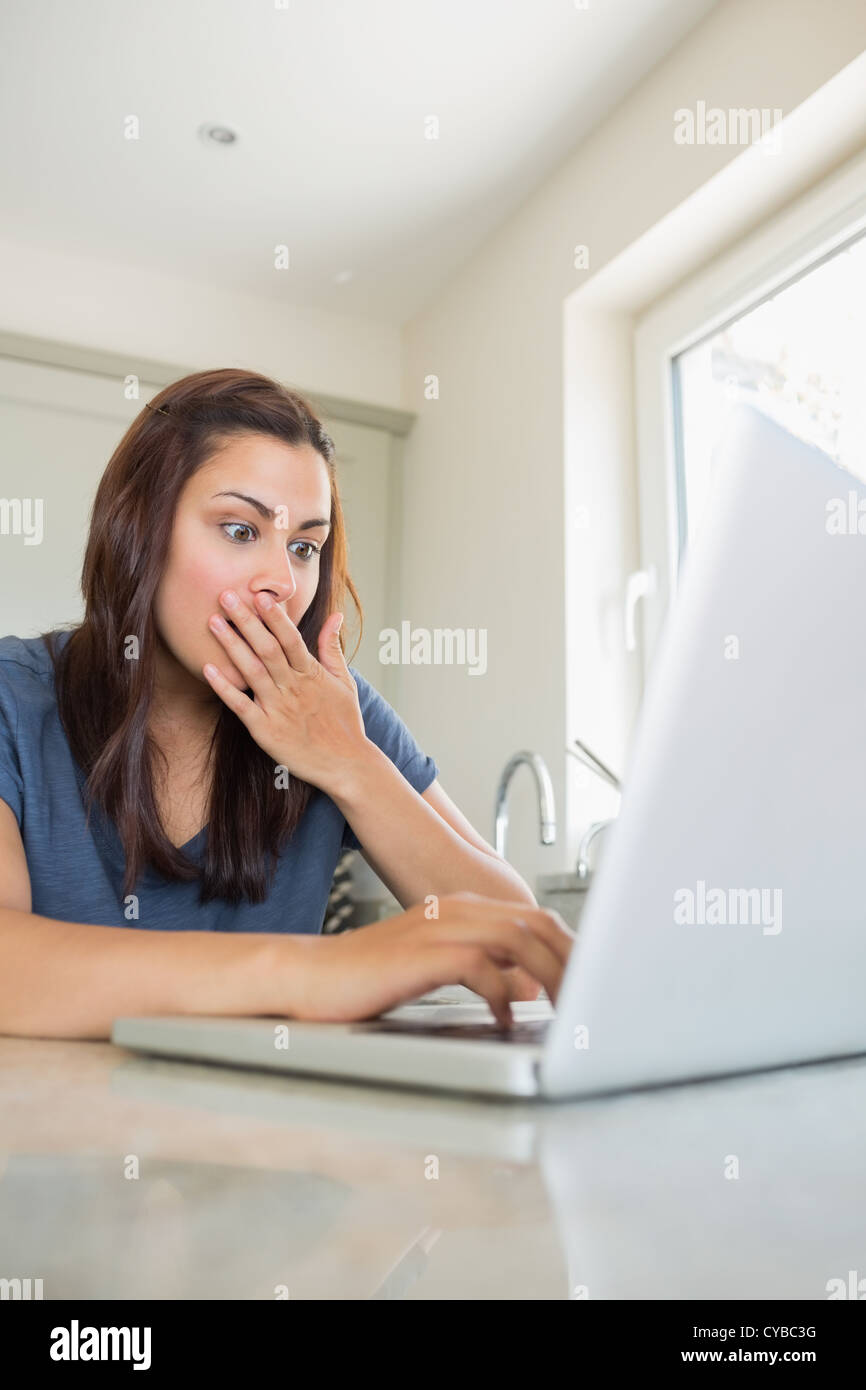 Surprised woman using the laptop Stock Photo - Alamy