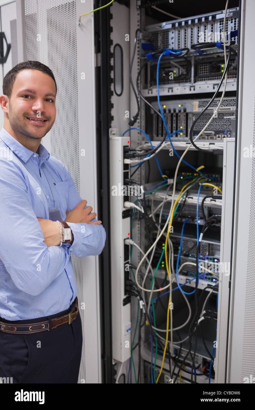 Smiling man standing in front of servers Stock Photo - Alamy