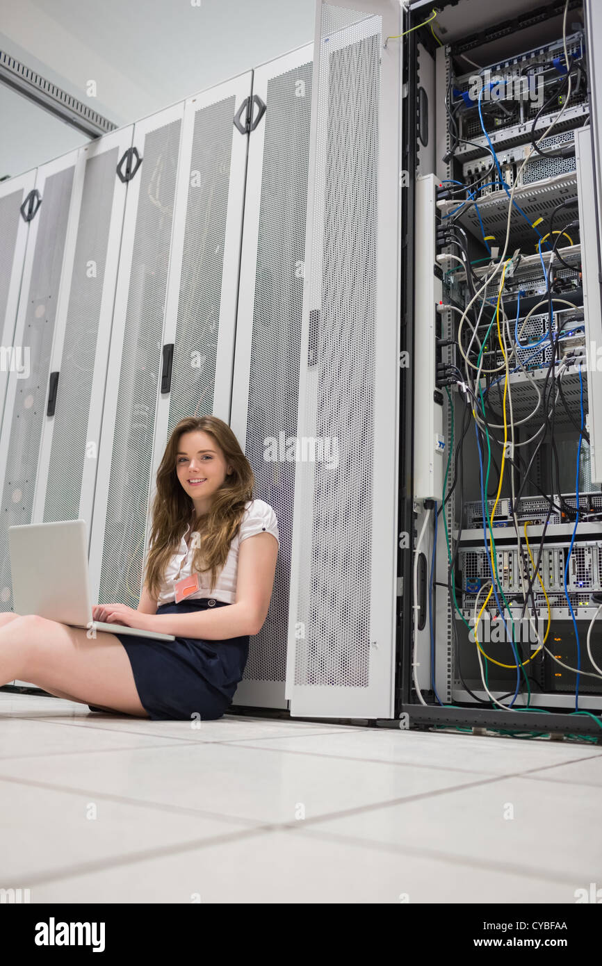 Smiling woman working with servers on laptop Stock Photo - Alamy