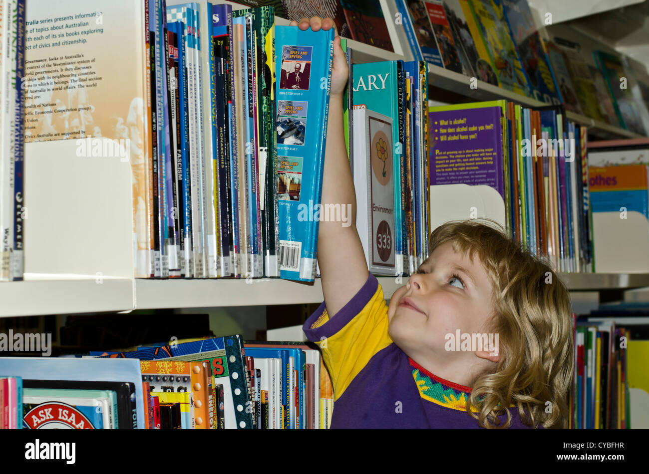 Bookshelf fiction reaching female hi-res stock photography and images ...