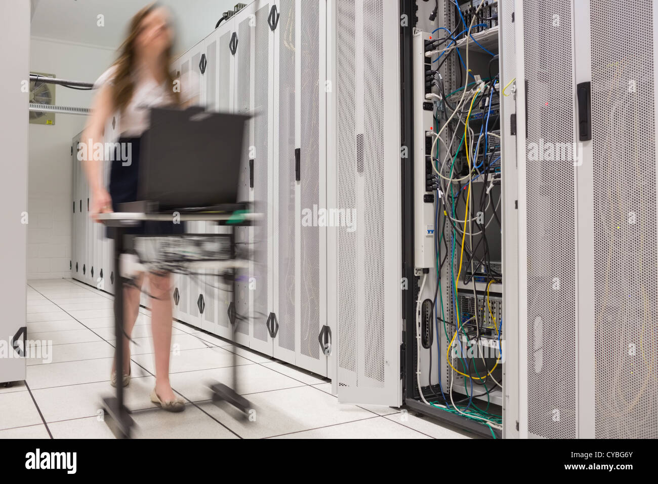 Woman pushing computer to open servers Stock Photo - Alamy