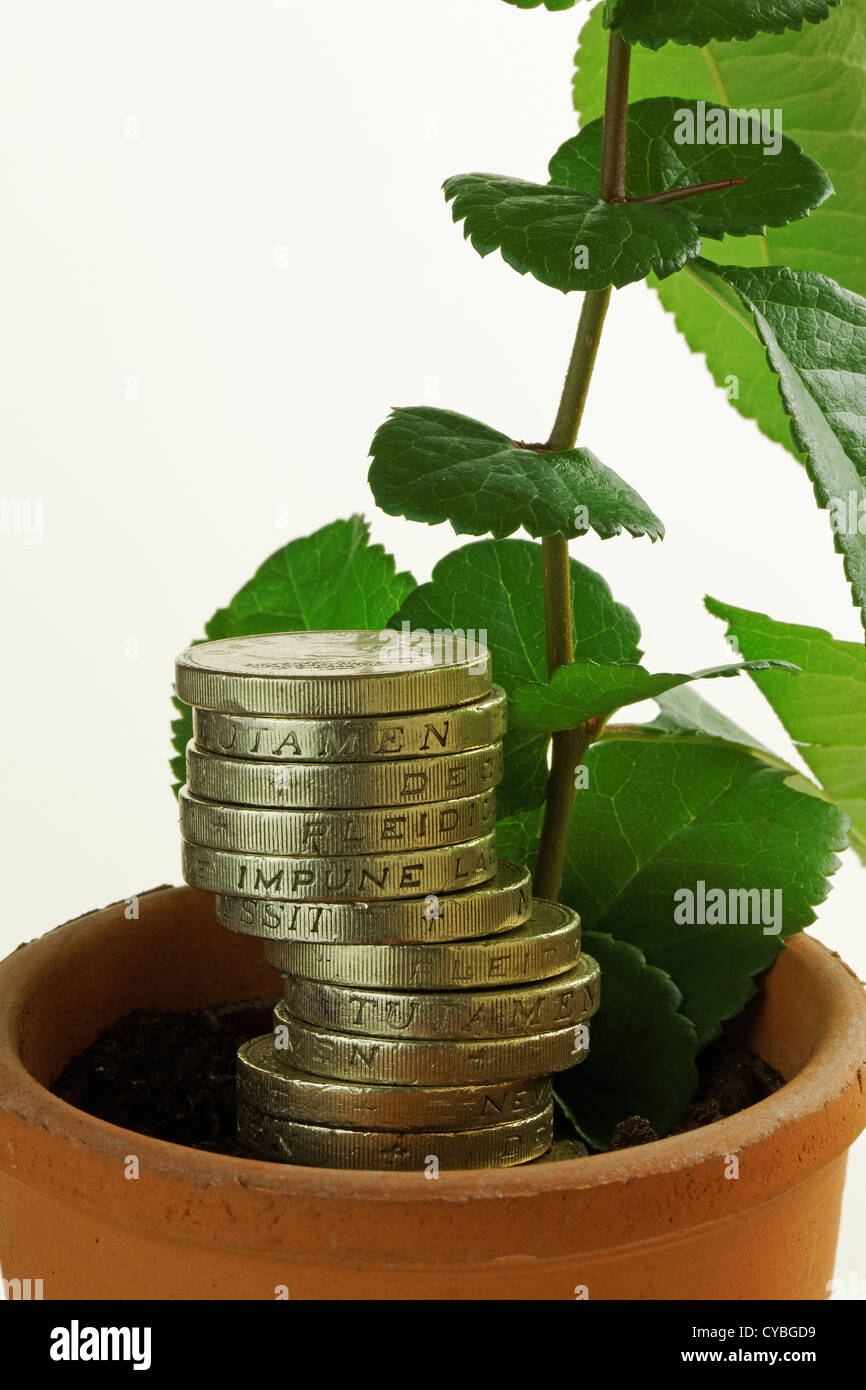 Pile of pound coins growing in a pot symbolising economic growth and ...