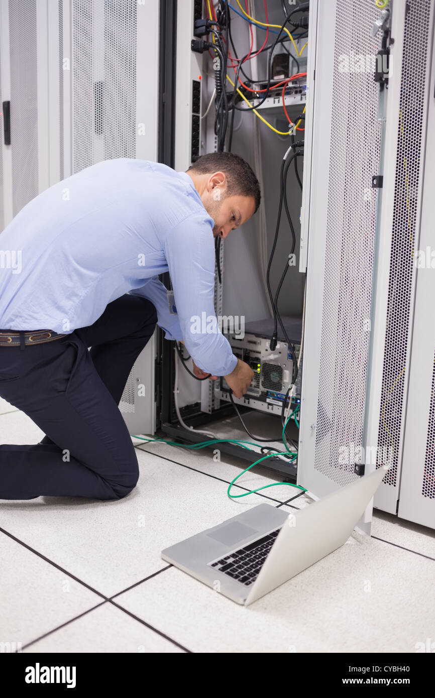 Man doing maintenance and fixing wires on server Stock Photo - Alamy
