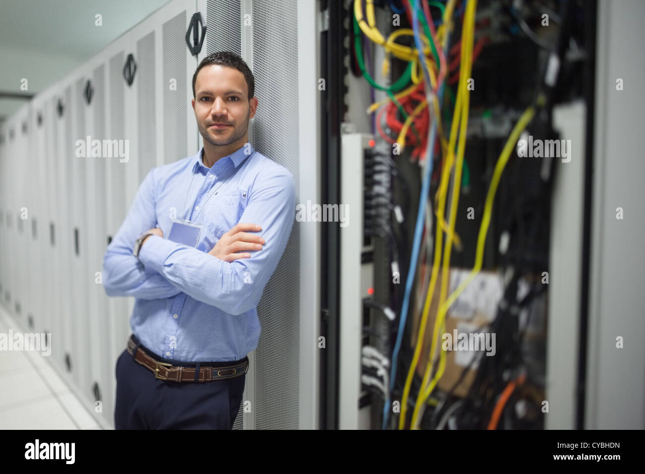 Man leaning against server locker Stock Photo - Alamy