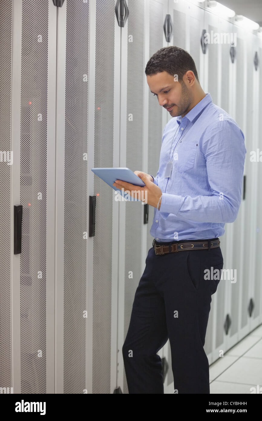 Technician doing maintenance with tablet pc in data center Stock Photo ...
