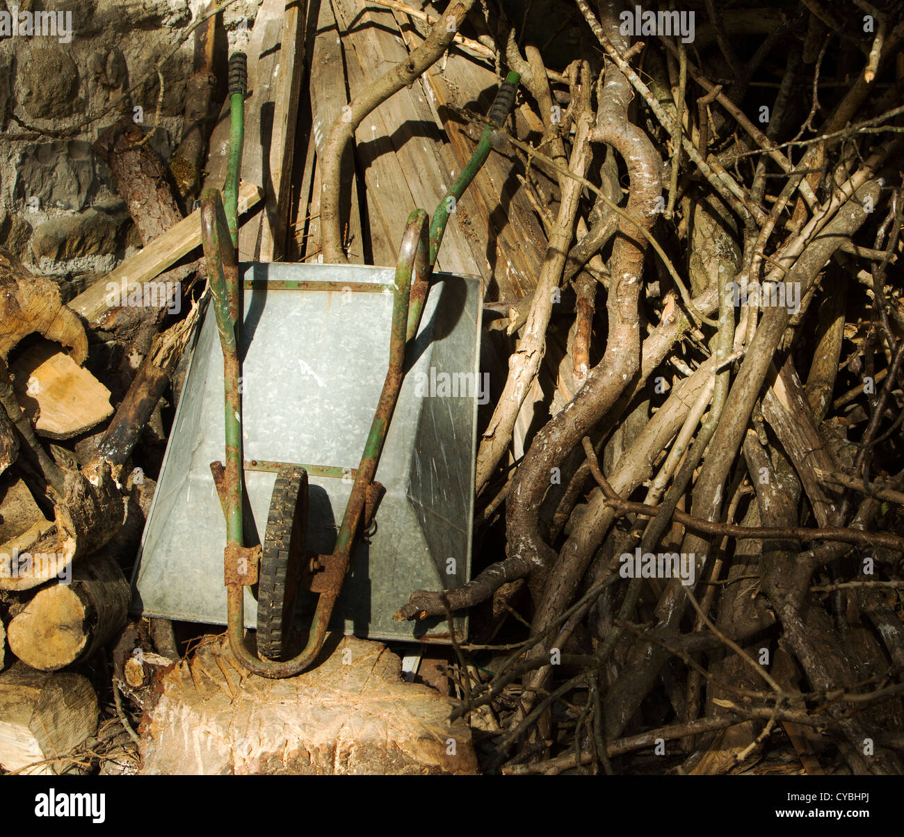 Untidy wood store with wheelbarrow Stock Photo - Alamy