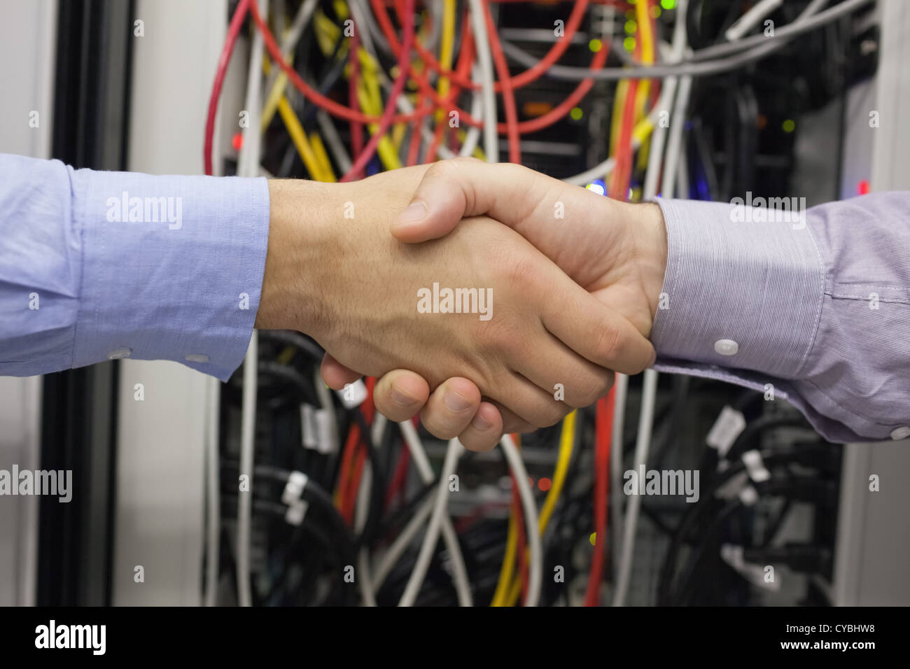 Hand shake in front of wires Stock Photo - Alamy