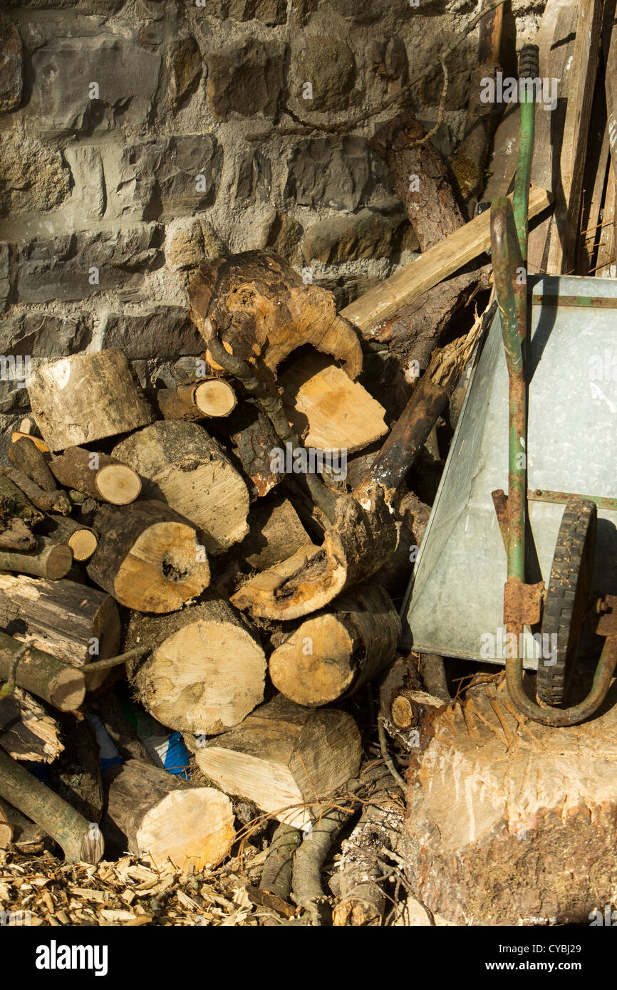 Untidy wood store with wheelbarrow Stock Photo - Alamy