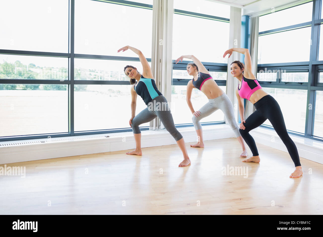 Women standing at the gym stretching Stock Photo - Alamy
