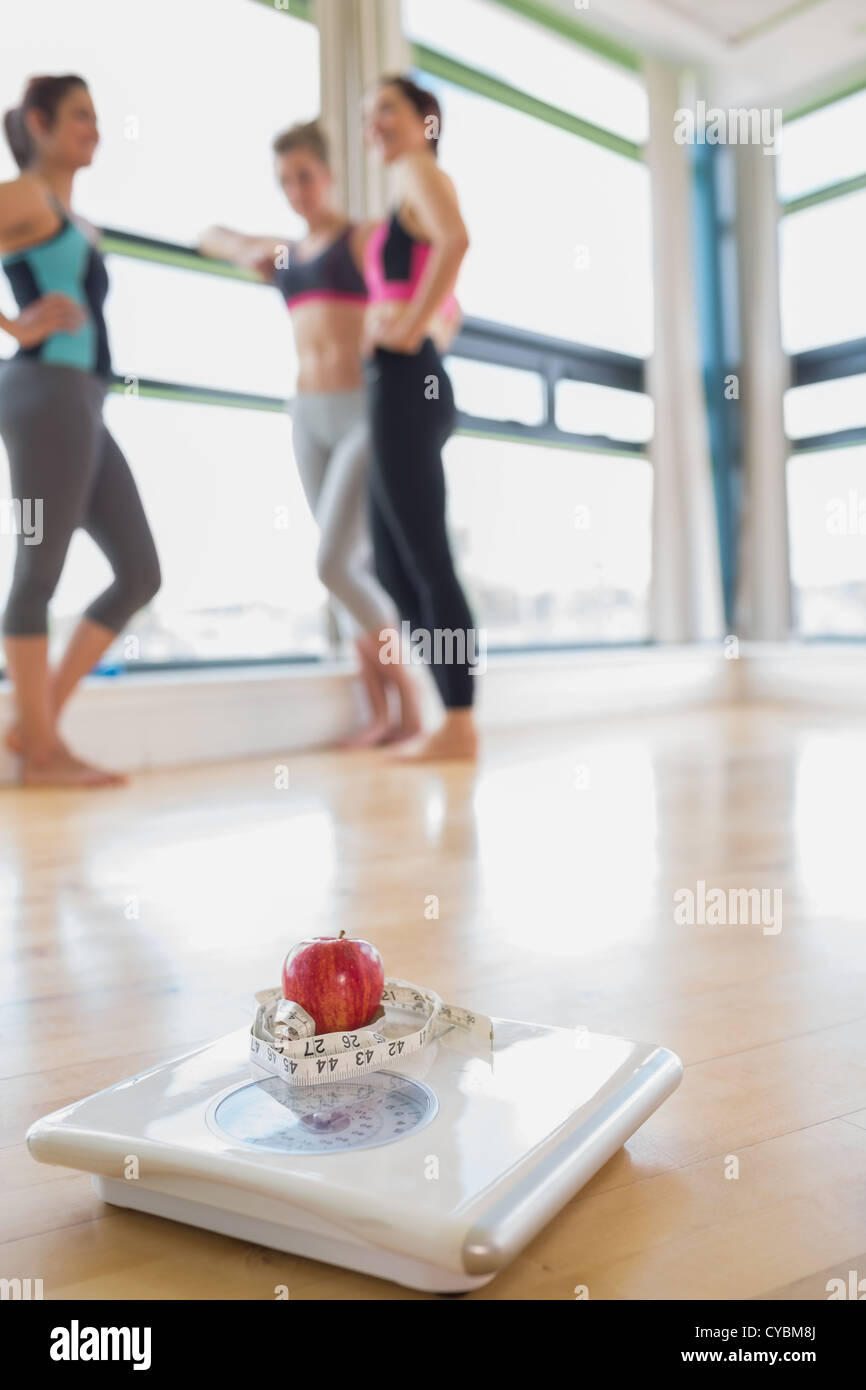 Scale with apple and measuring tape Stock Photo - Alamy