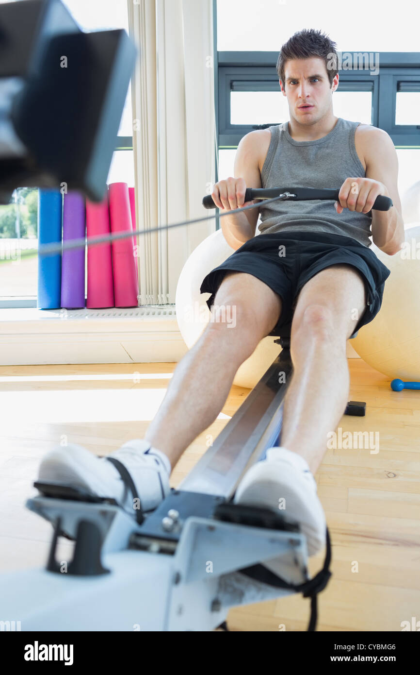 Man sitting at the row machine Stock Photo - Alamy