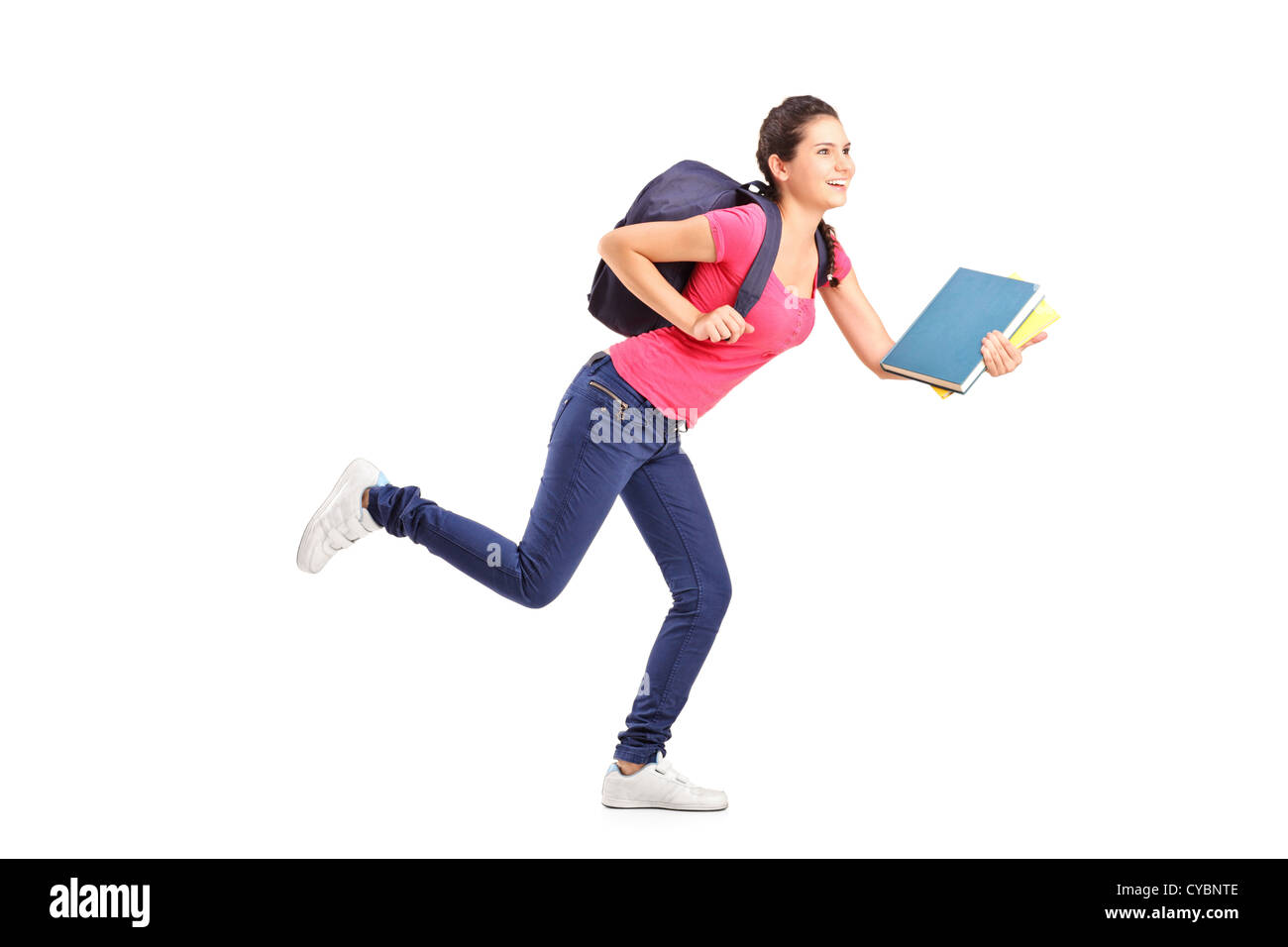 Young female student rushing forwards with book in her hand Stock Photo ...