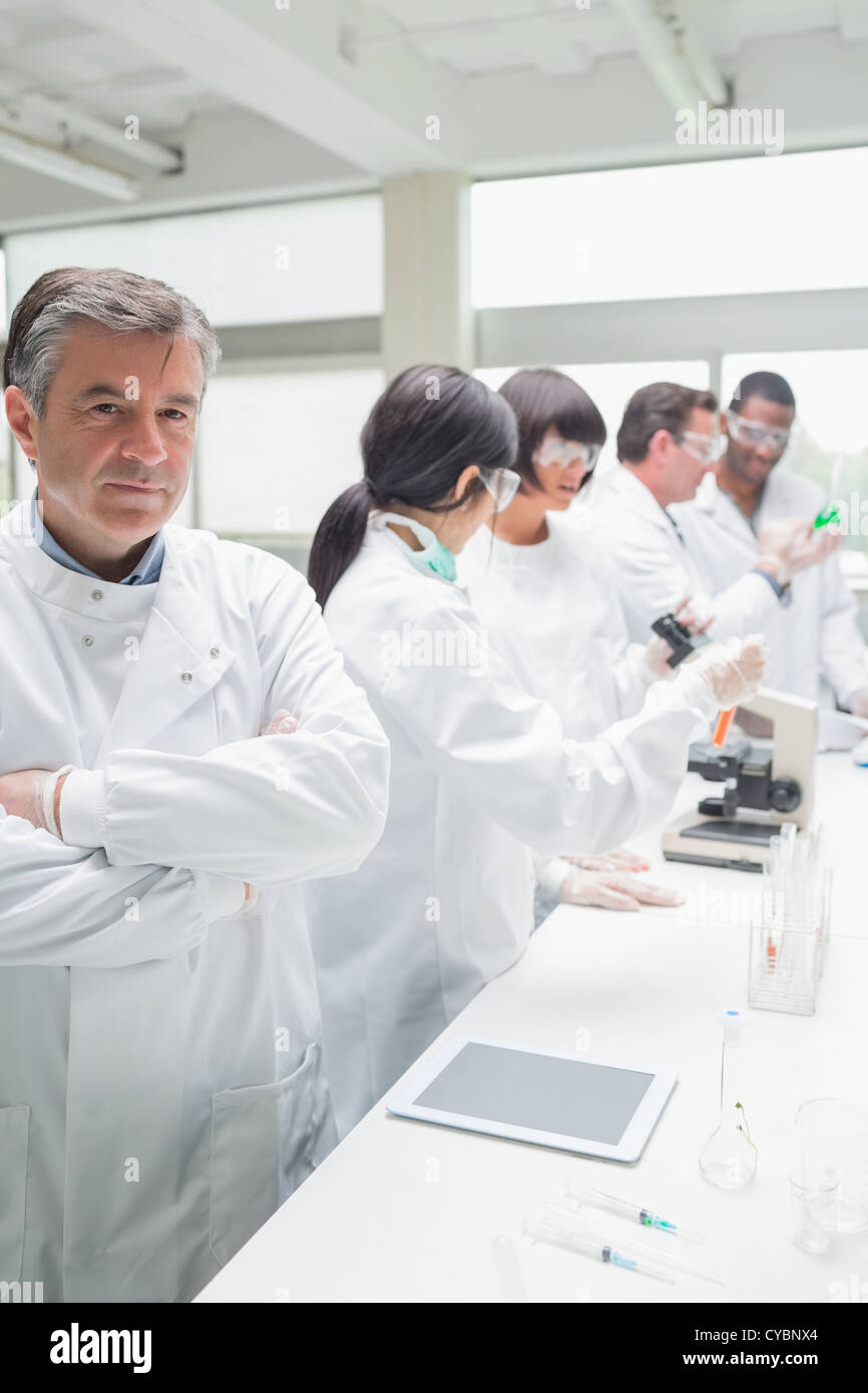 Chemist standing in front of tablet pc Stock Photo - Alamy