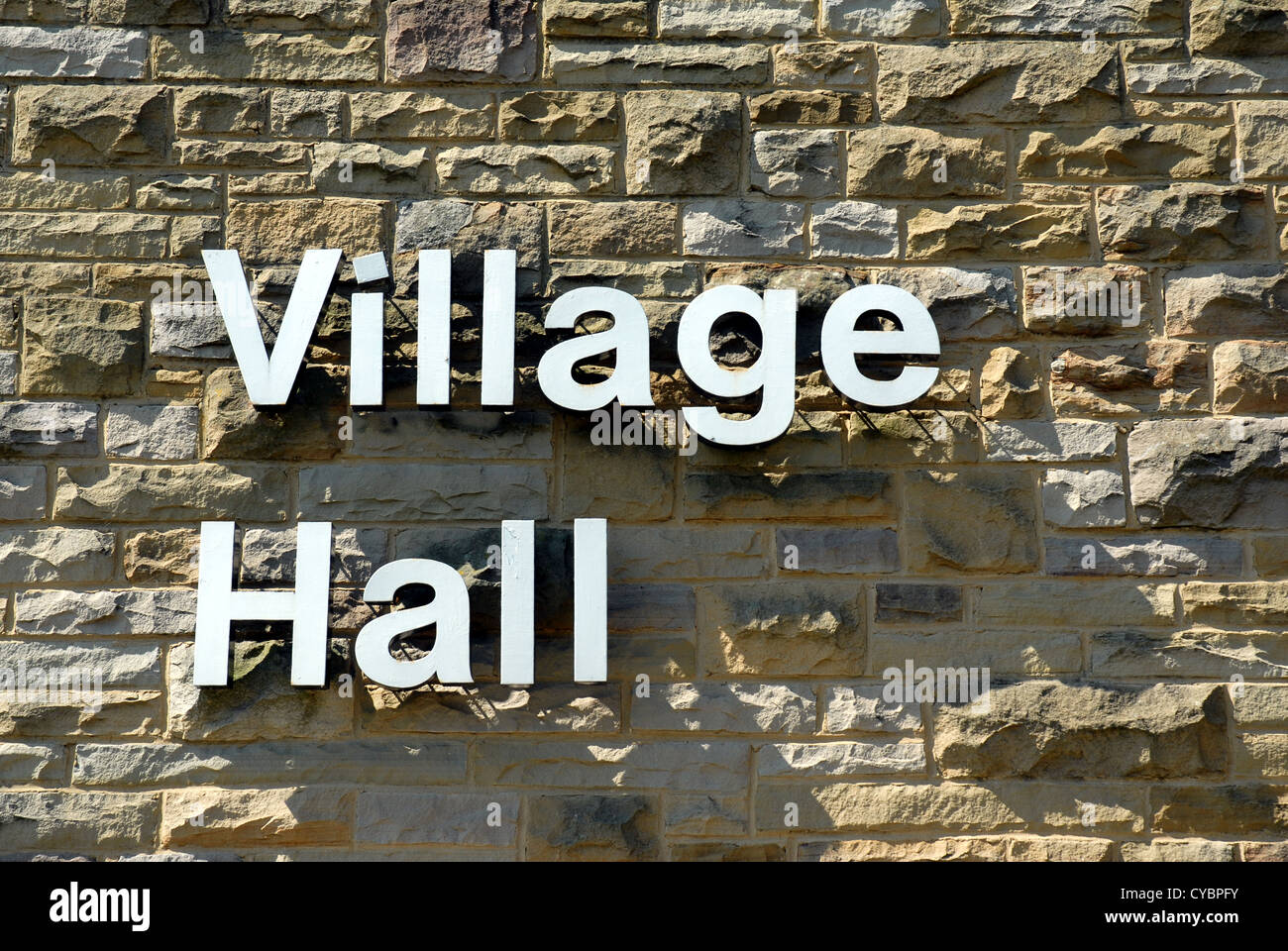Village Hall sign mounted on a stone brick wall in England, UK Stock ...
