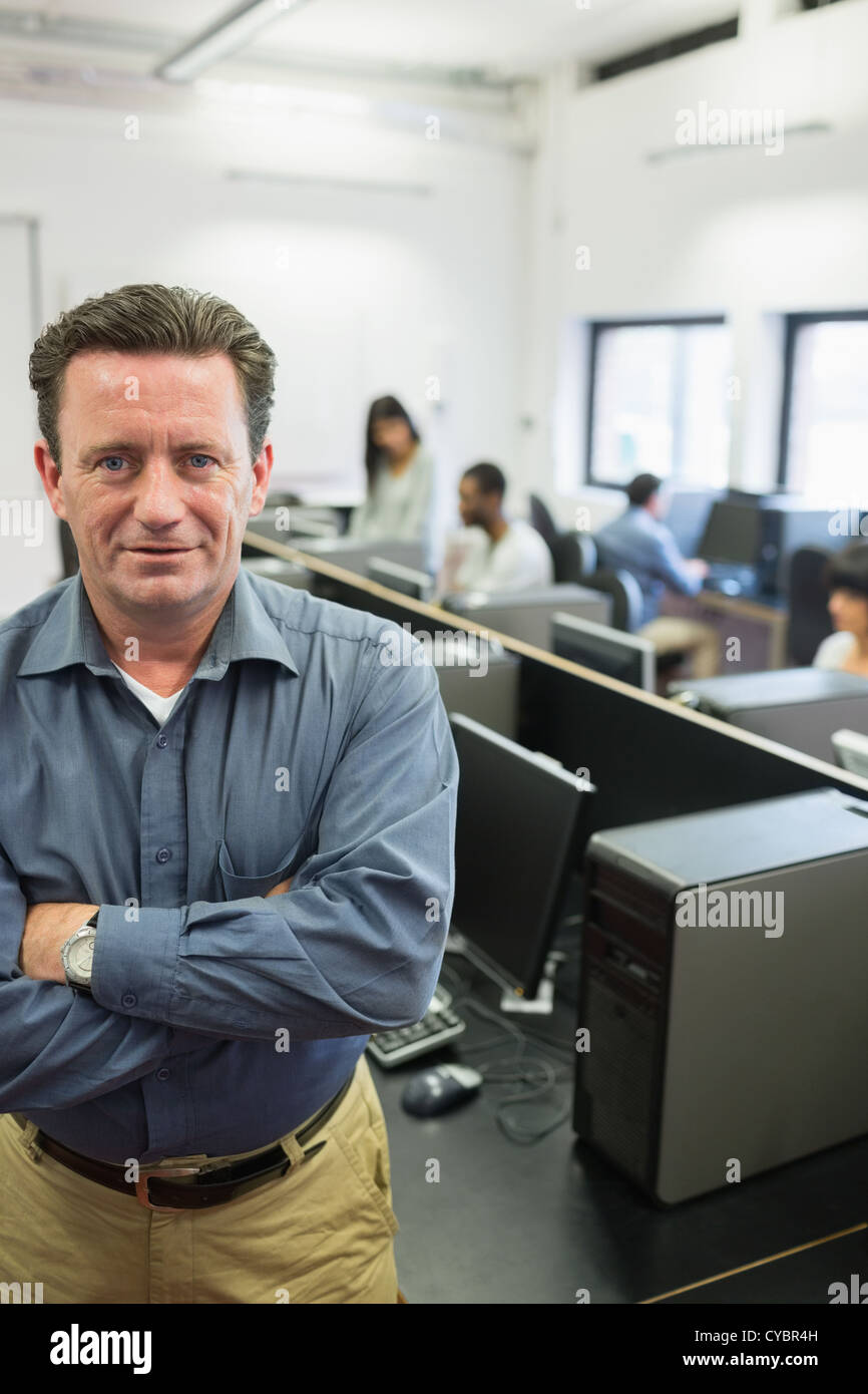 Man with crossed arms in computer class Stock Photo - Alamy