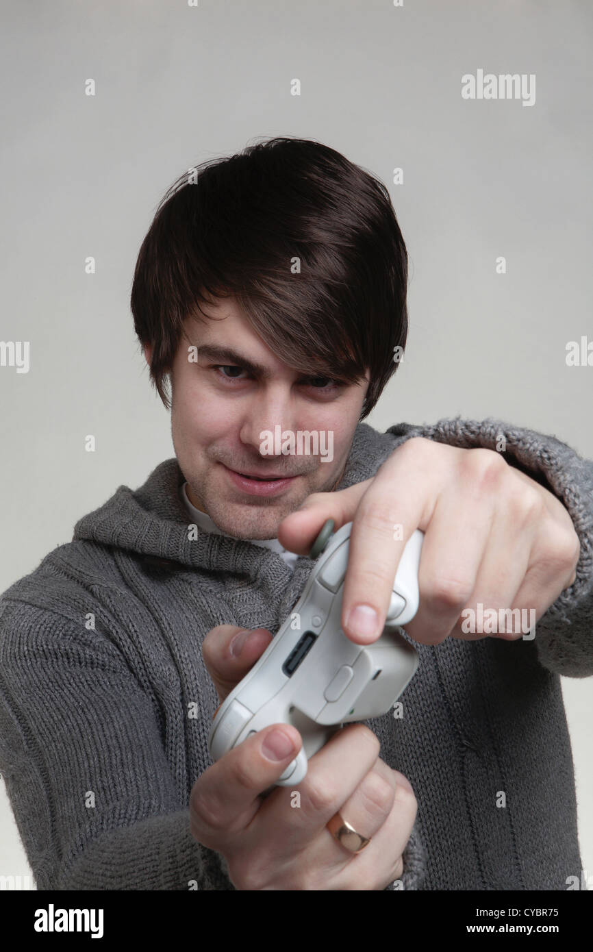 young guy playing a video game Stock Photo - Alamy
