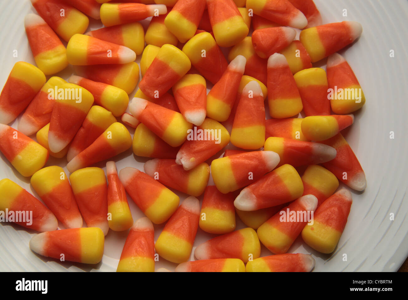 Candy Corn on white plate Stock Photo - Alamy