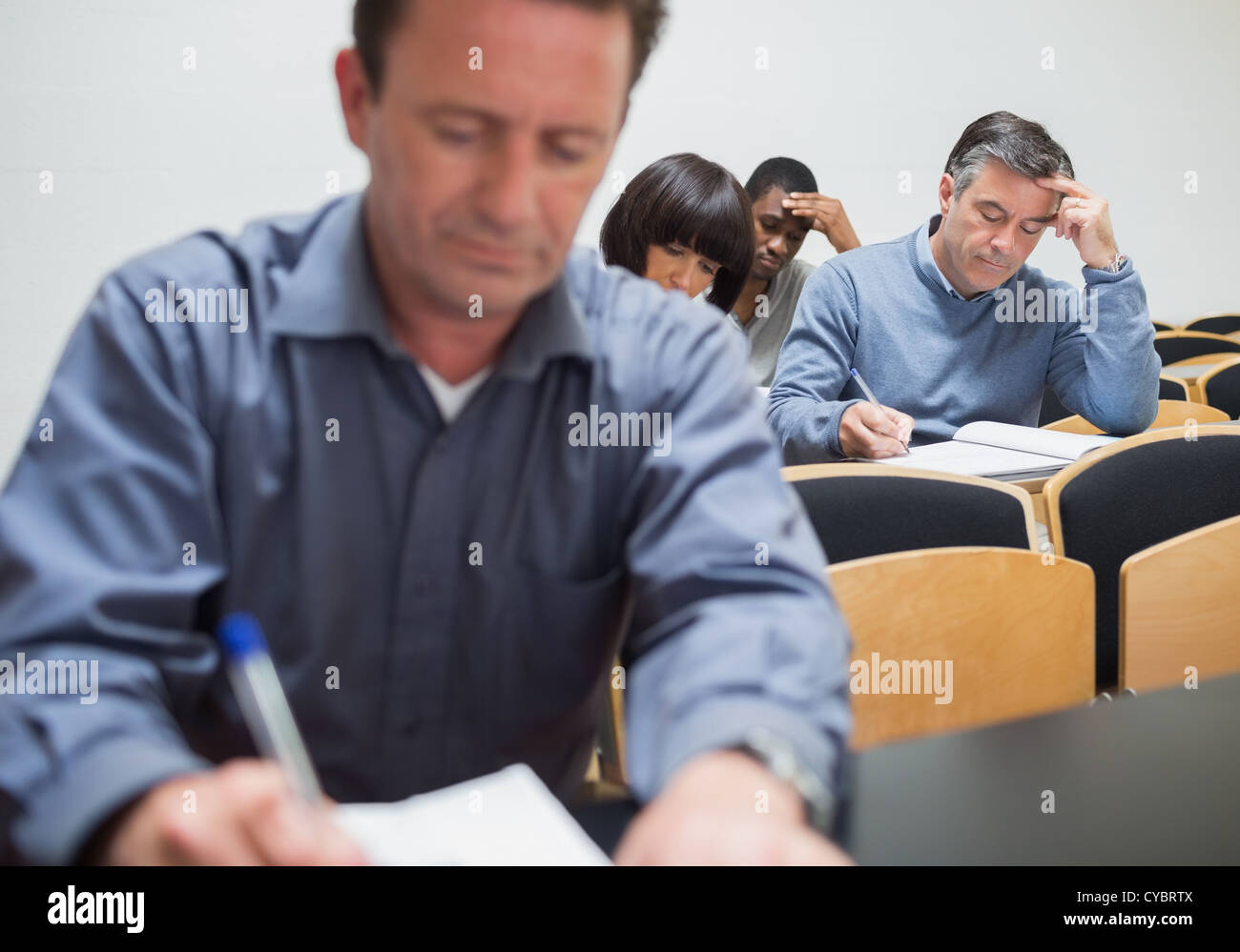 Class taking notes Stock Photo - Alamy