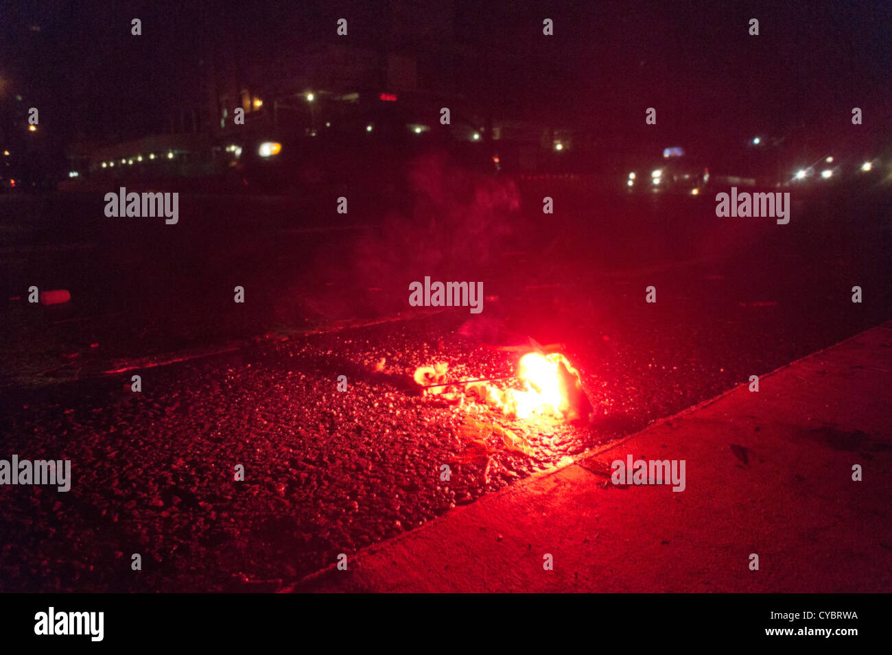 Flares burn at a dark intersection in the Chelsea neighborhood of New ...