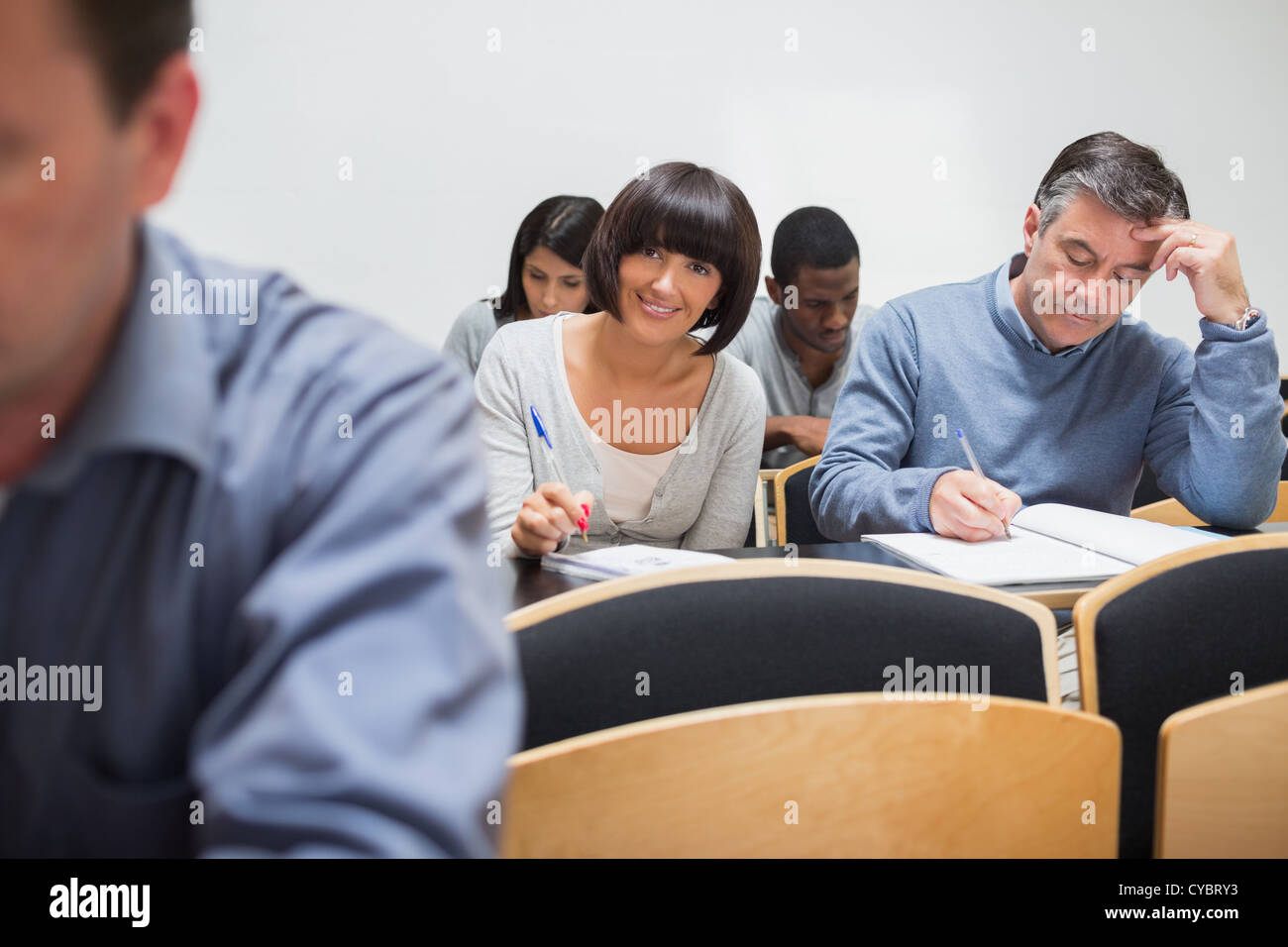 Adult class having fun while learning Stock Photo - Alamy