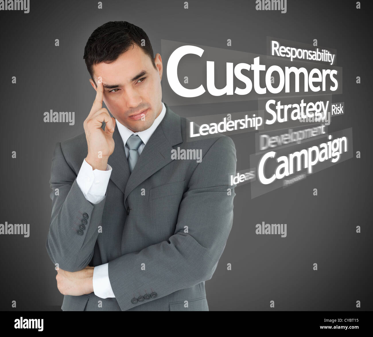 Businessman standing thinking black background Stock Photo - Alamy