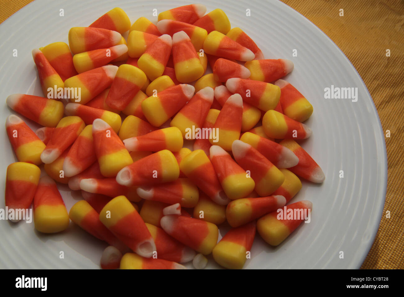 Candy Corn on white plate Stock Photo - Alamy