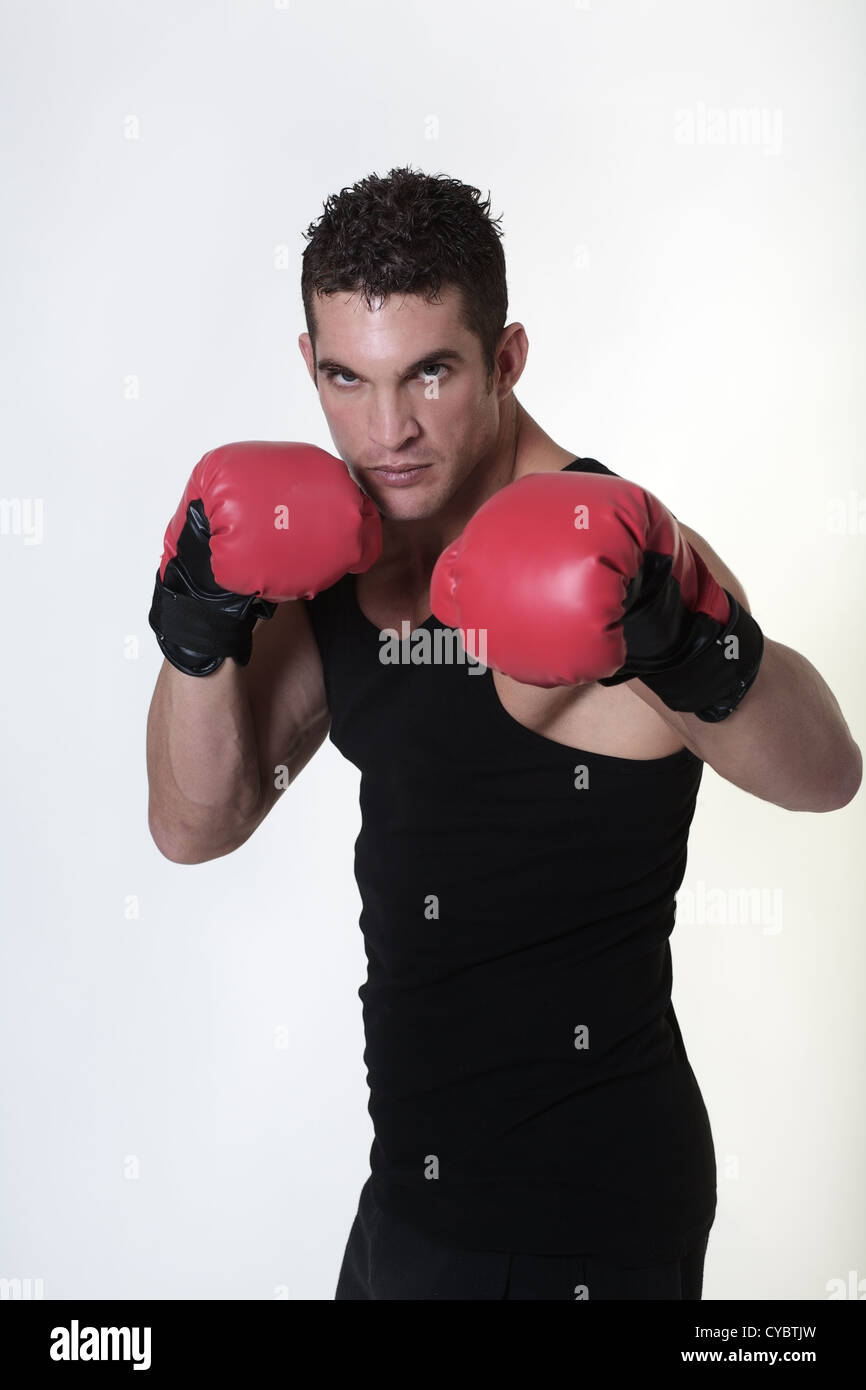 good looking man wearing boxing gloves and working out Stock Photo - Alamy