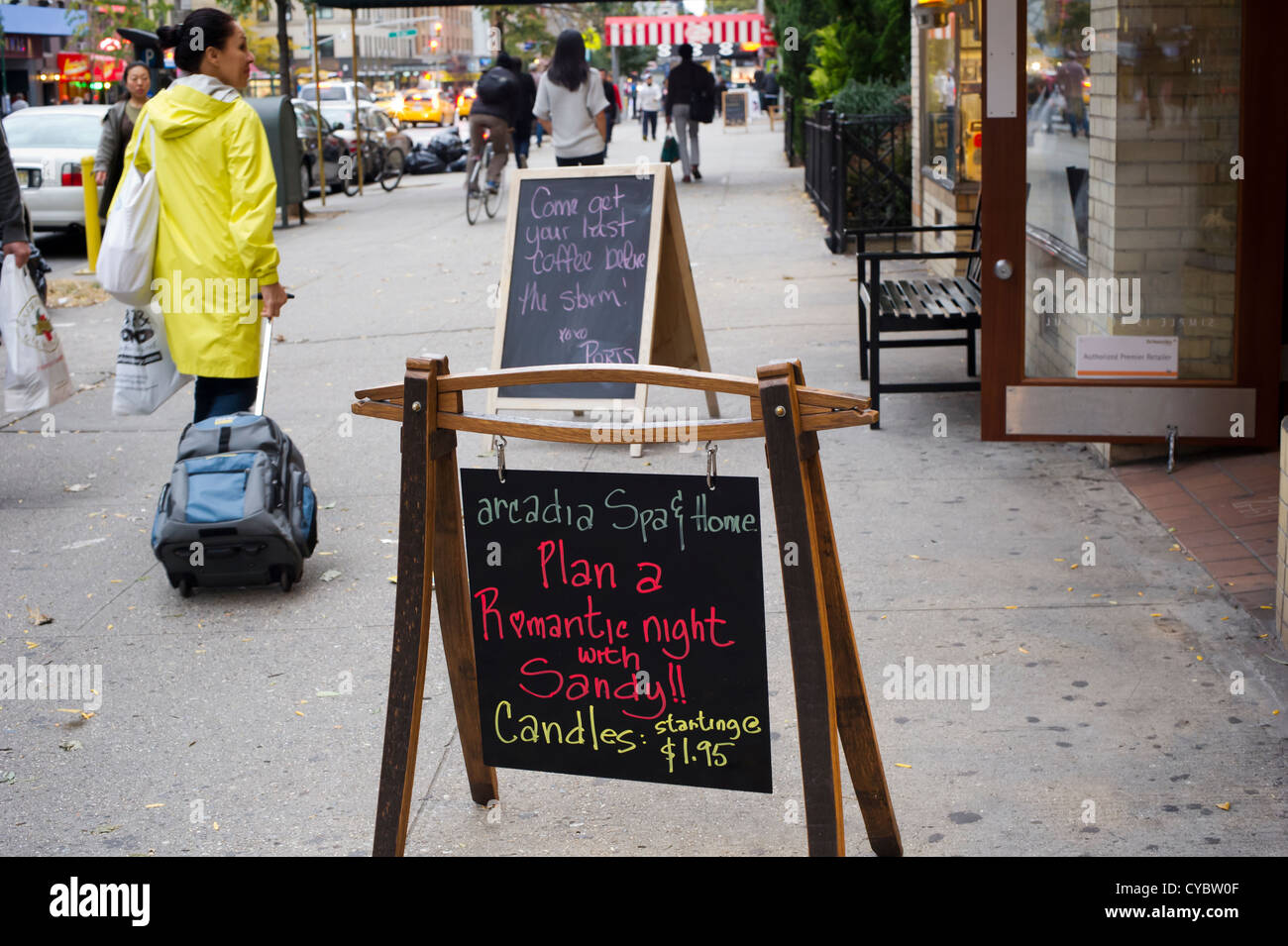A pedestrian wheeling luggage passes store signs referencing Hurricane ...