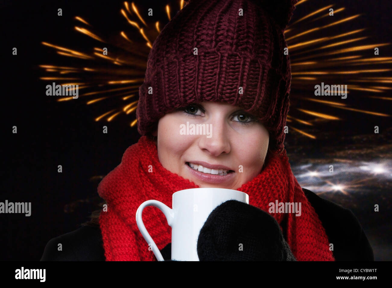 woman looking cold in winter clothes drinking a hot drink to keep warm ...