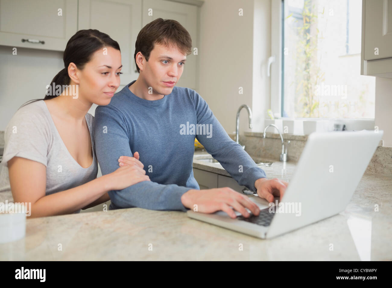 Couple looking at laptop Stock Photo - Alamy