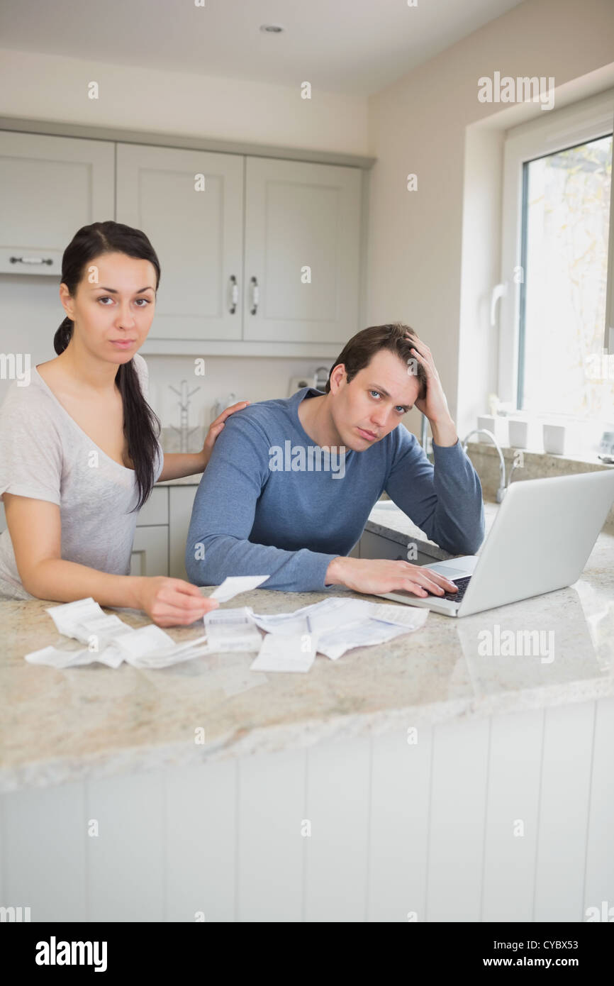 Couple calculating with the laptop Stock Photo - Alamy