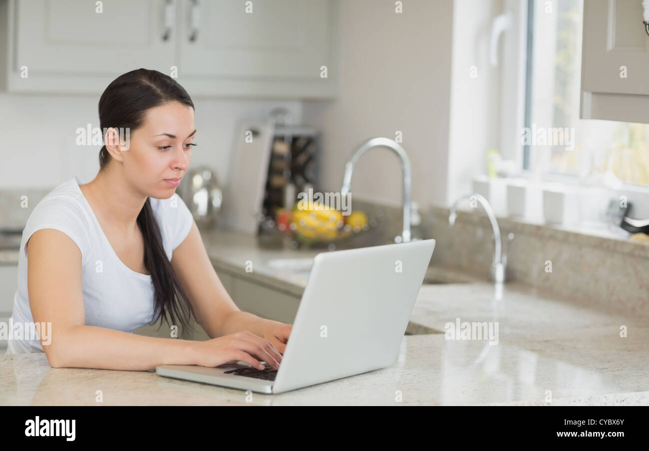 Woman sitting in the kitchen Stock Photo - Alamy