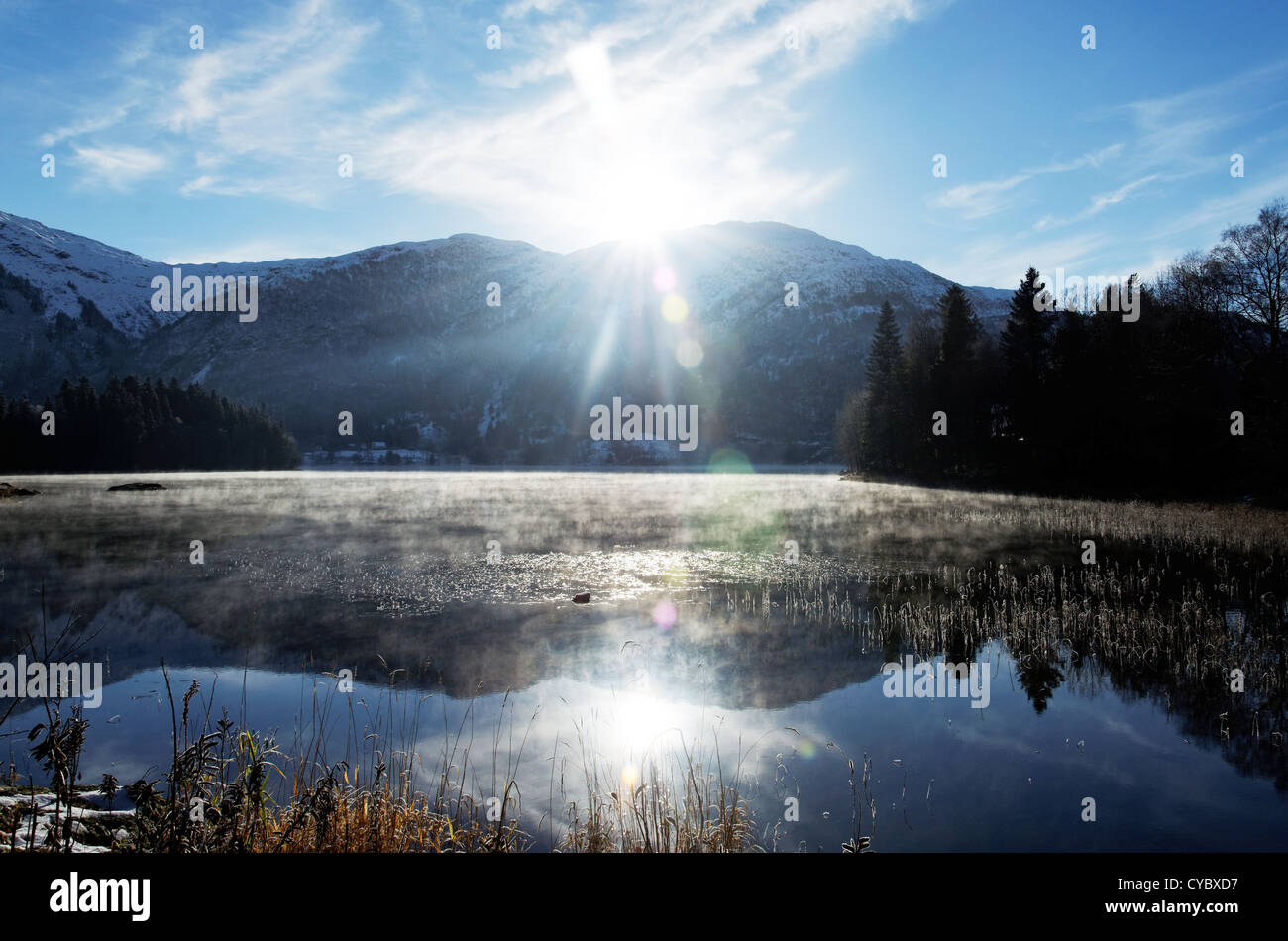 Sun going down over a cold mountaintop Stock Photo - Alamy