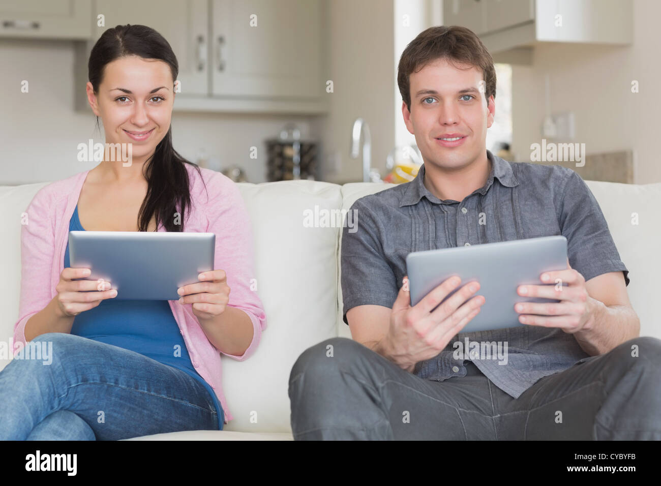 Two friends using a tablet computer Stock Photo - Alamy