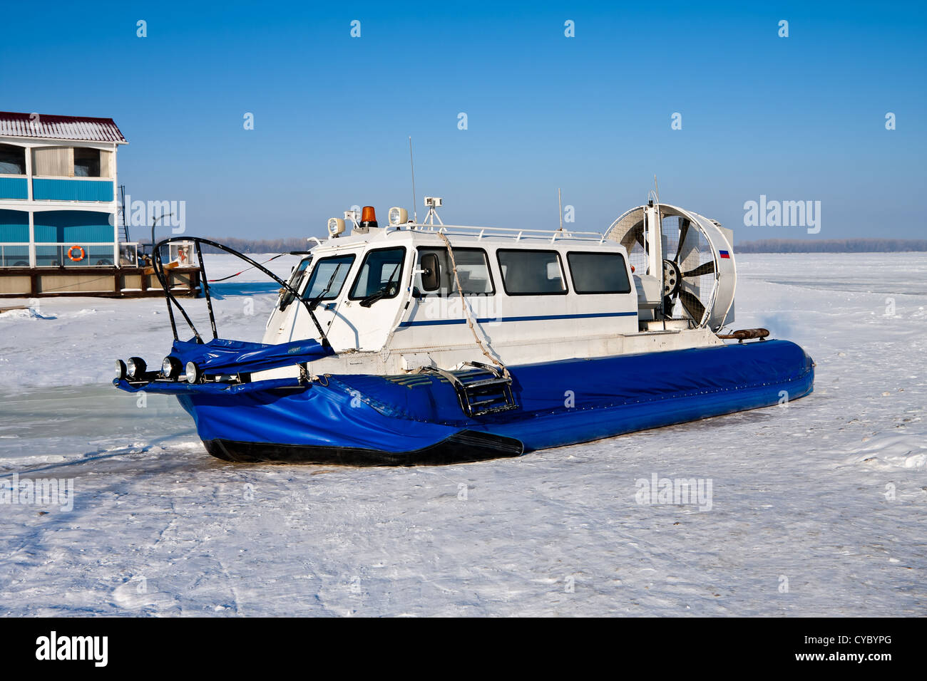 Hovercraft crossing frozen river against a blue sky Stock Photo - Alamy