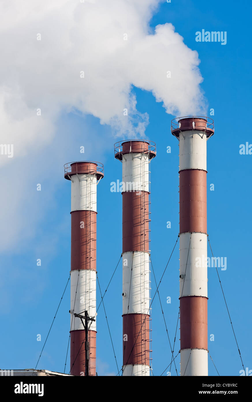 Lots of smoking chimneys other blue sky Stock Photo - Alamy