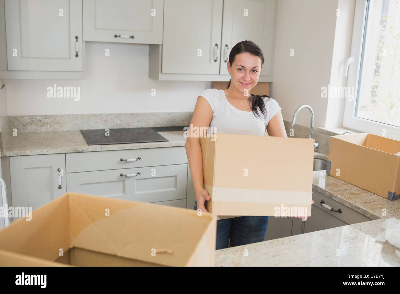 Young woman unpacking Stock Photo - Alamy