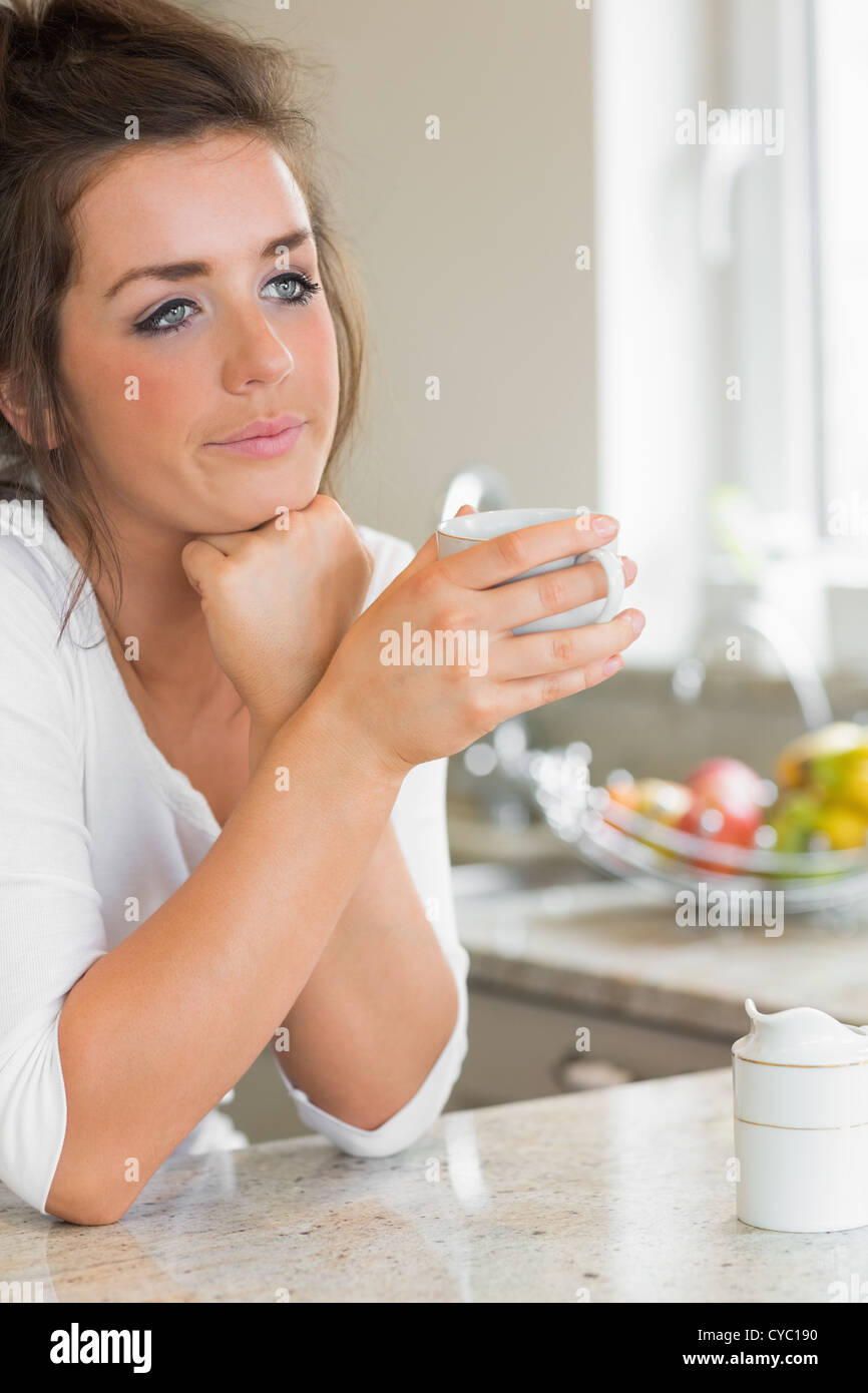 Thinking woman having coffee Stock Photo - Alamy