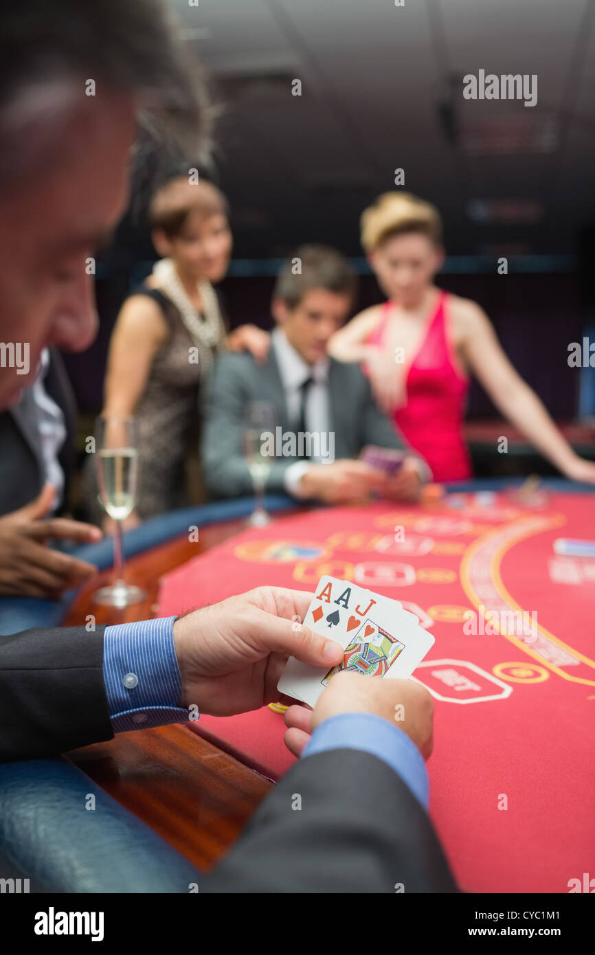 Man looking at his cards Stock Photo - Alamy