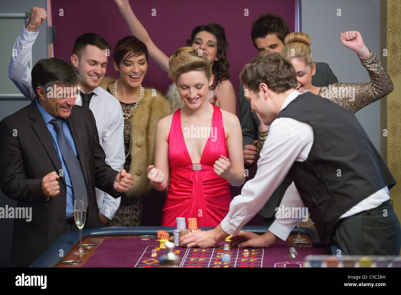 People cheering at roulette table Stock Photo - Alamy