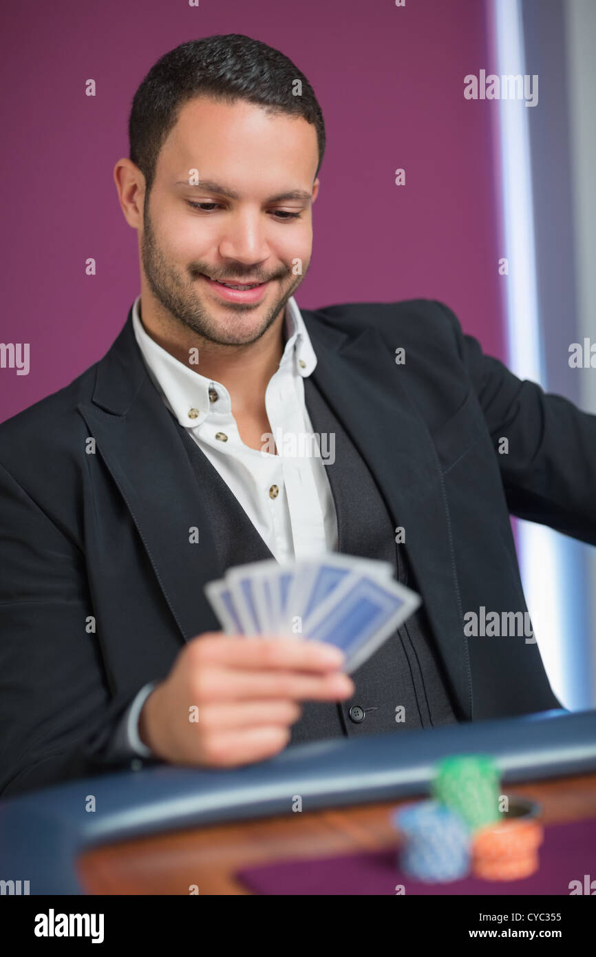 Man holding cards smiling Stock Photo - Alamy