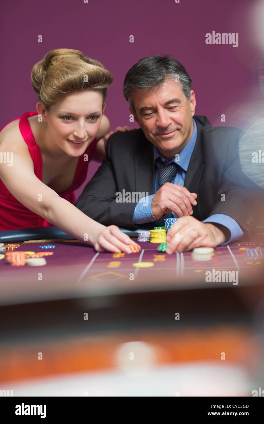 Woman and man placing bets Stock Photo - Alamy