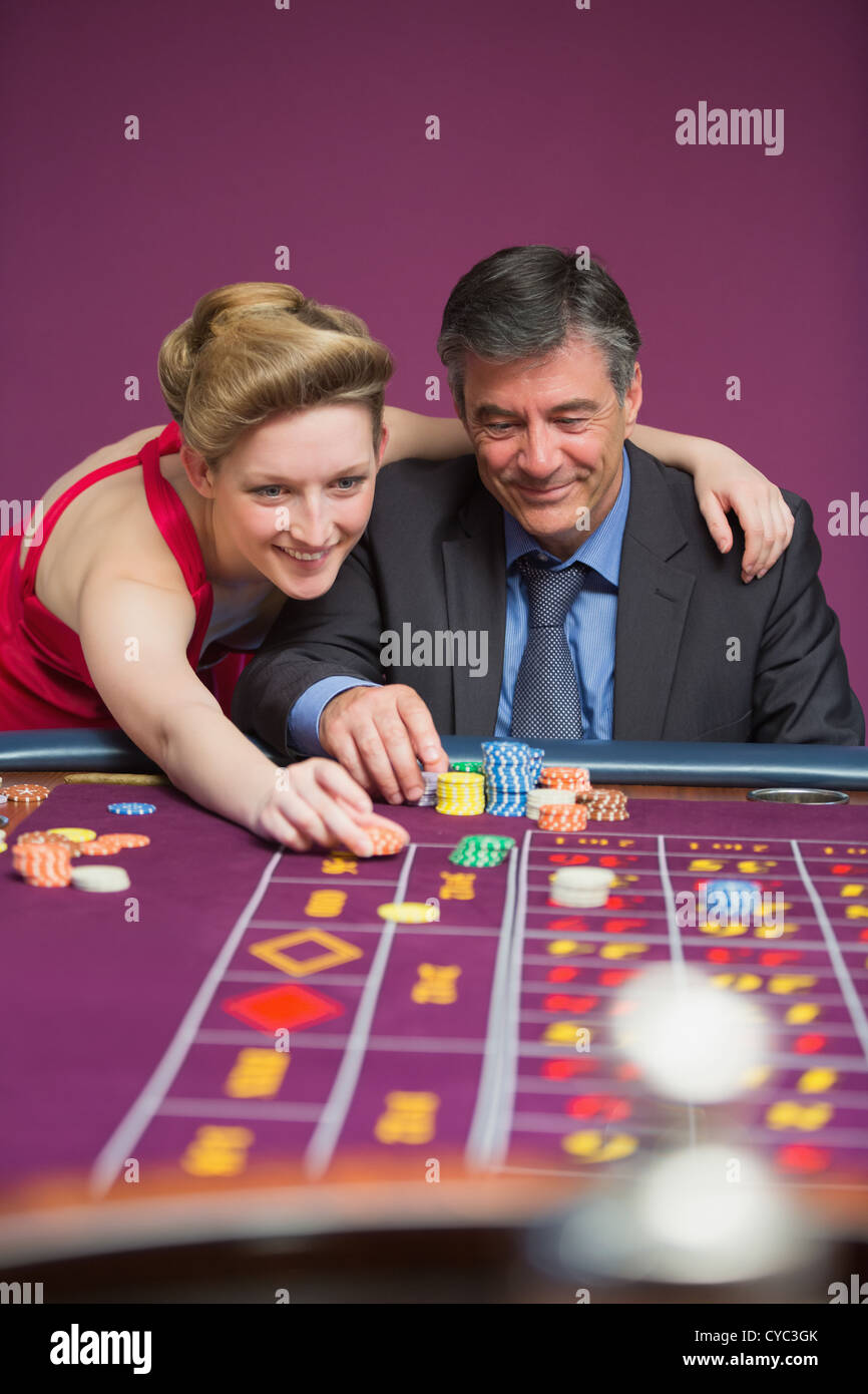 Woman placing bet for man Stock Photo - Alamy