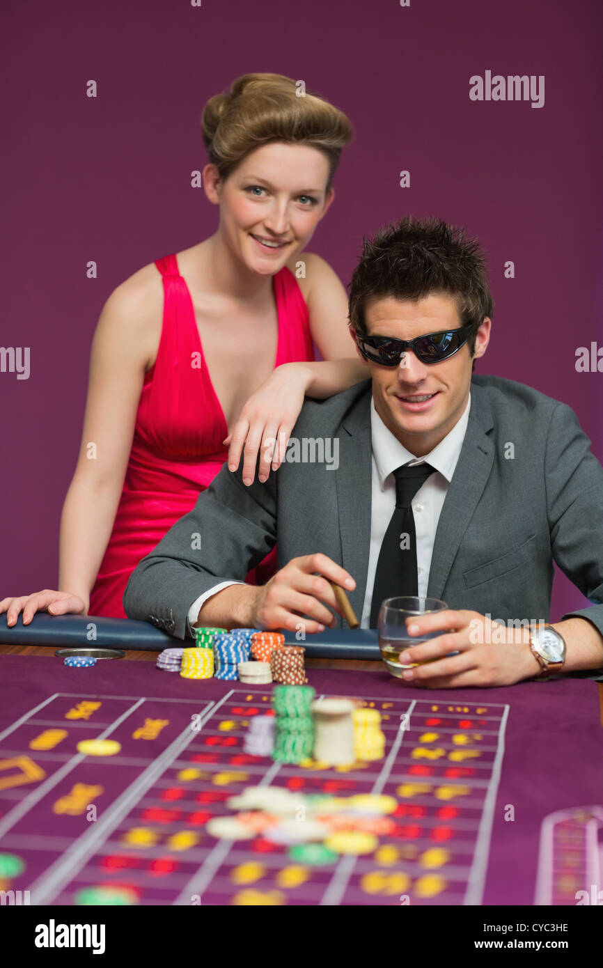 Couple smiling at the table Stock Photo - Alamy