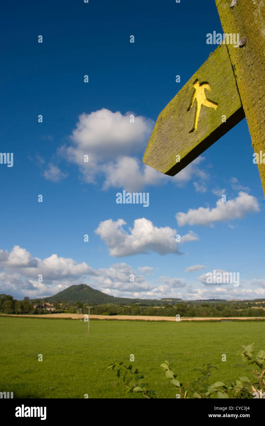 Wooden public footpath sign, blue sky, fluffy clouds and the Wrekin in ...